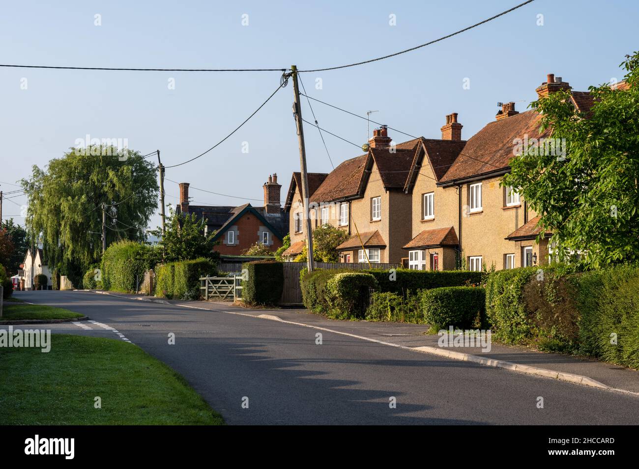 Cottages and semi-detached houses line the main street of Motcombe ...
