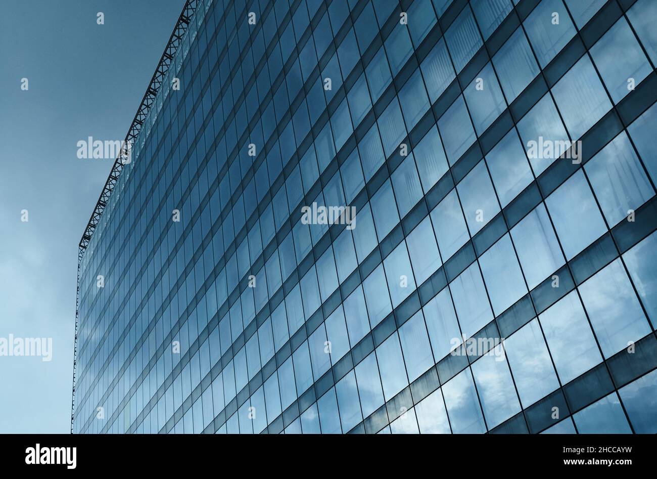 Cloudy sky reflection on a high glass building facade Stock Photo - Alamy