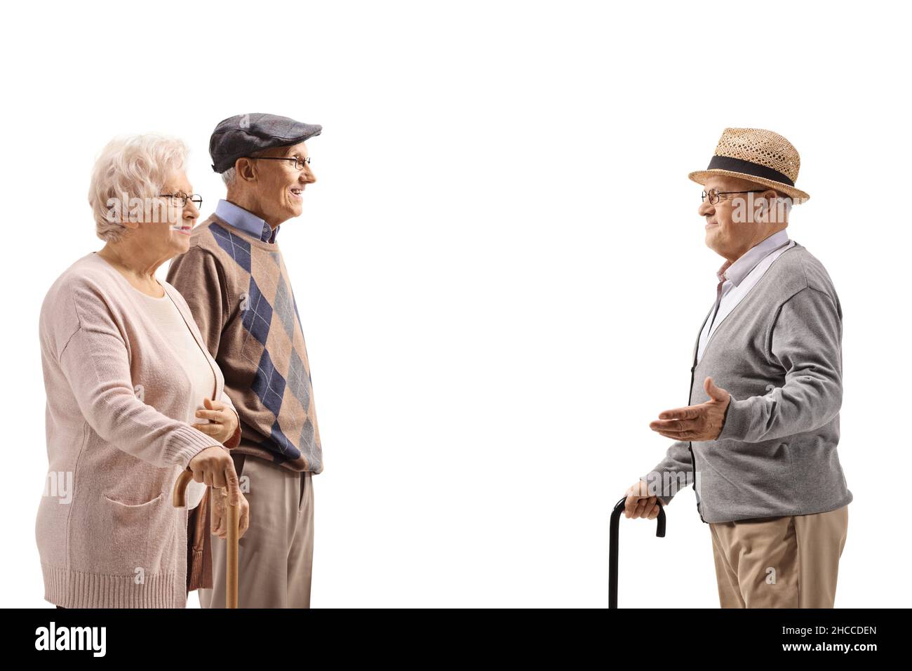 Edlerly man talking to an elderly couple isolated on white background ...