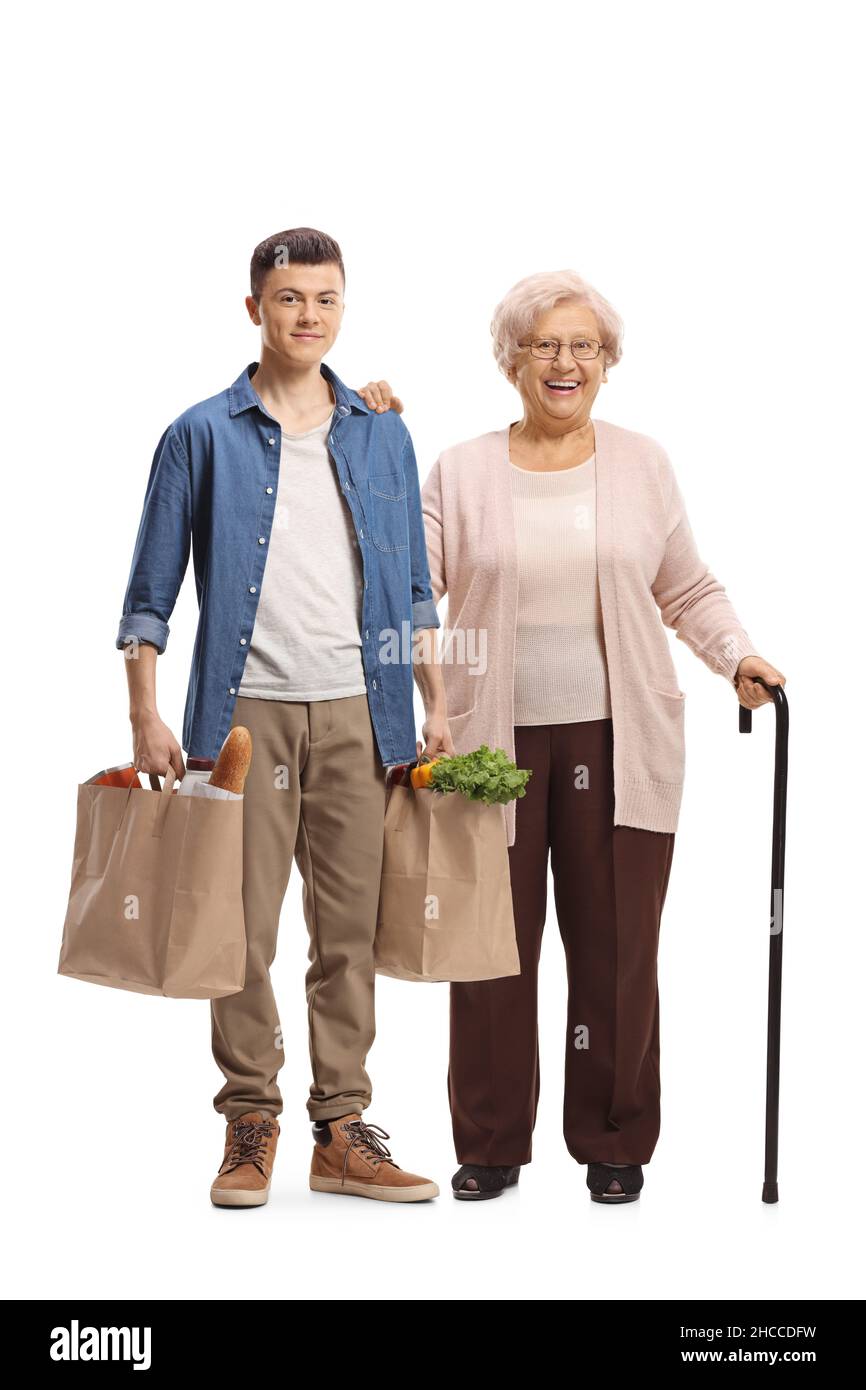 Young man helping an elderly woman and carrying grocery bags isolated ...