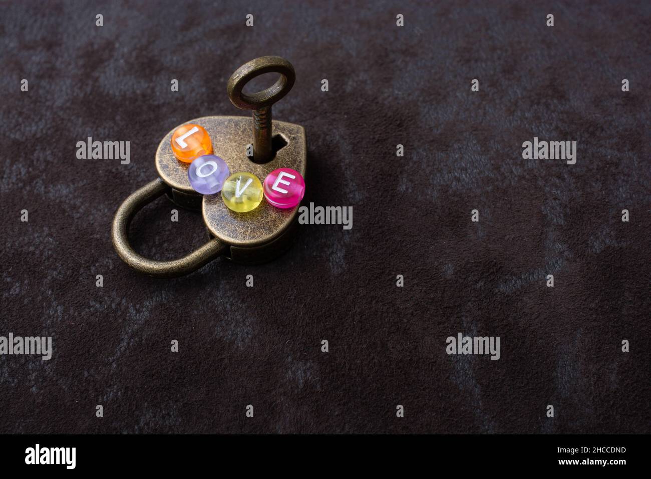 High-angle shot of a heart-shaped lock with the LOVE letters on it ...