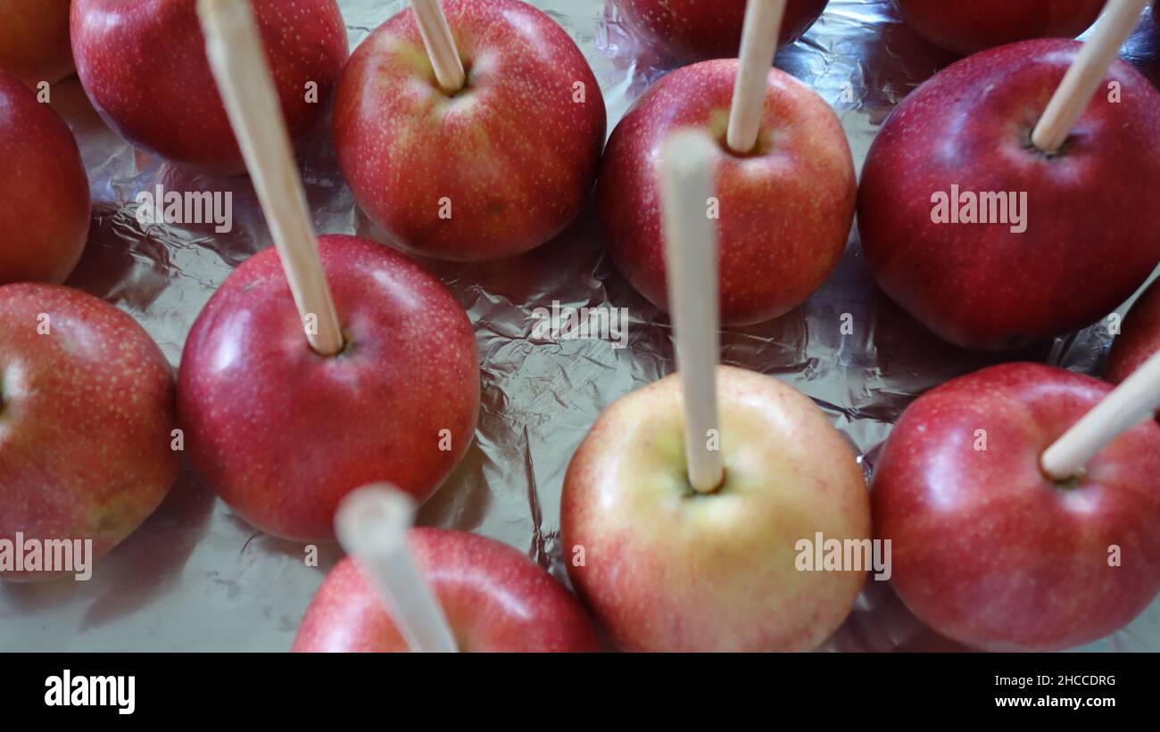 Small red apples with wooden stick. Apples ready for wrapping with ...