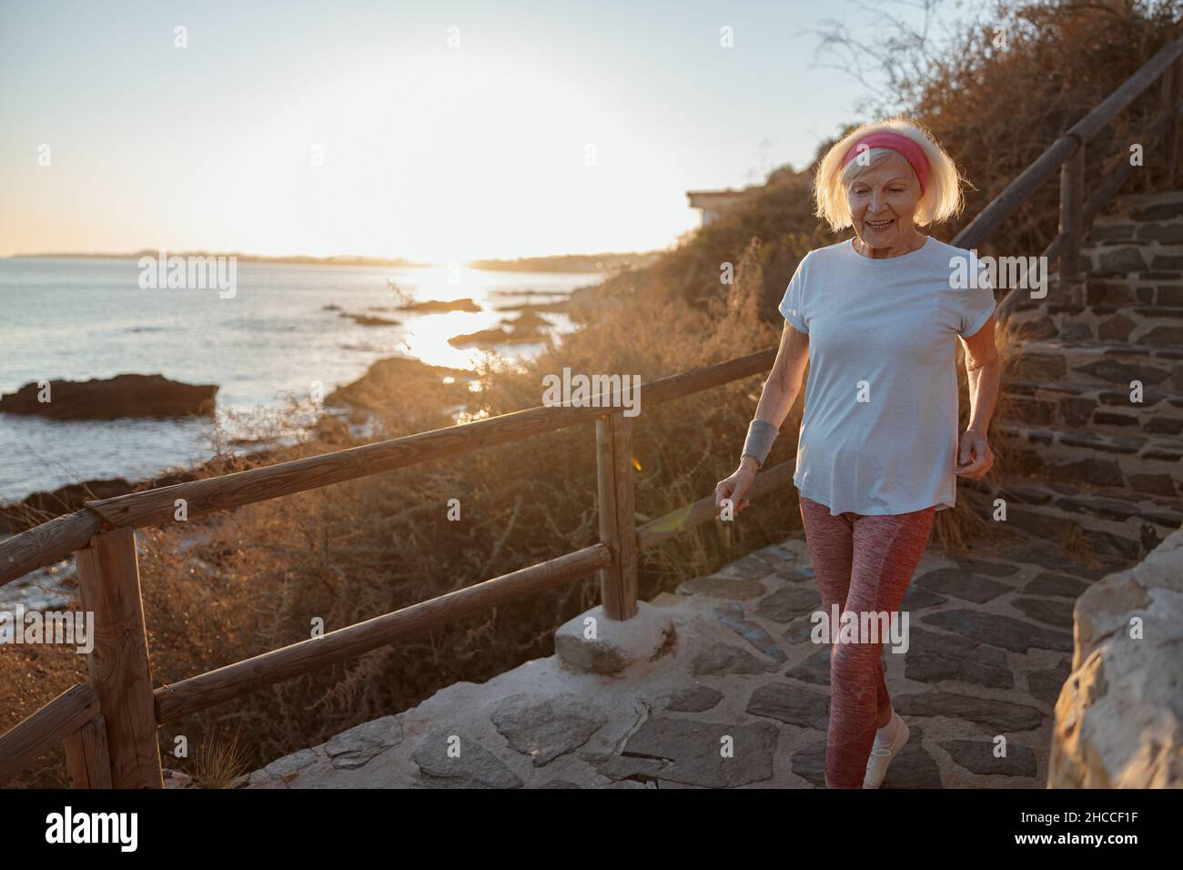 Woman walking through the park hi-res stock photography and images - Alamy