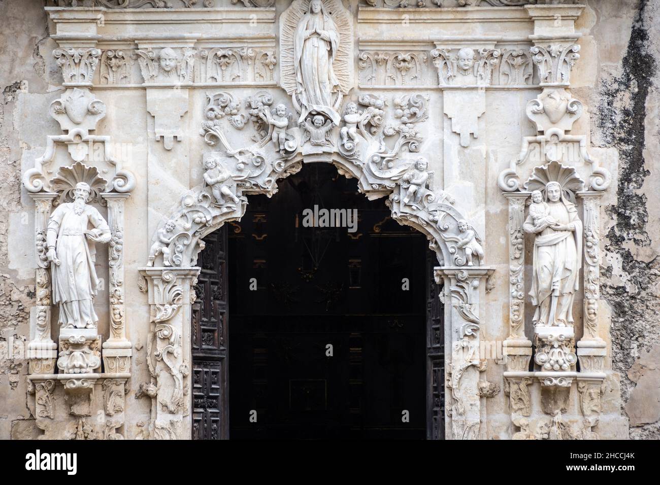 Ornate stone carvings surround the open entrance to Mission San Jose ...