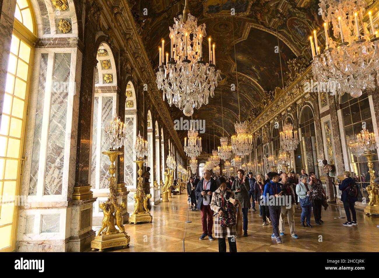 Mesmerizing view of the Hall of Mirrors and tourists in the Palace of ...