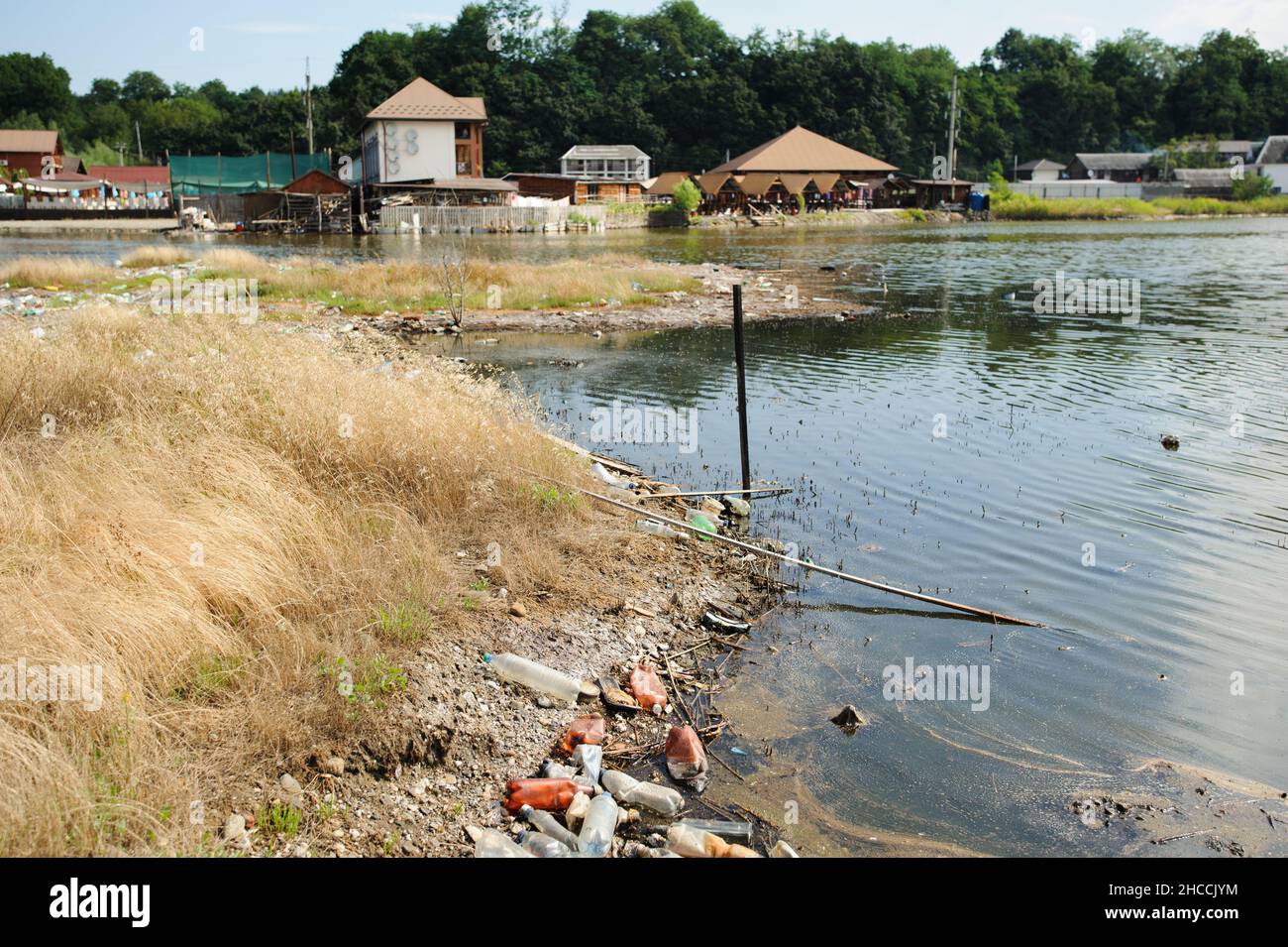 The lake and the shore are littered with the garbage Stock Photo - Alamy