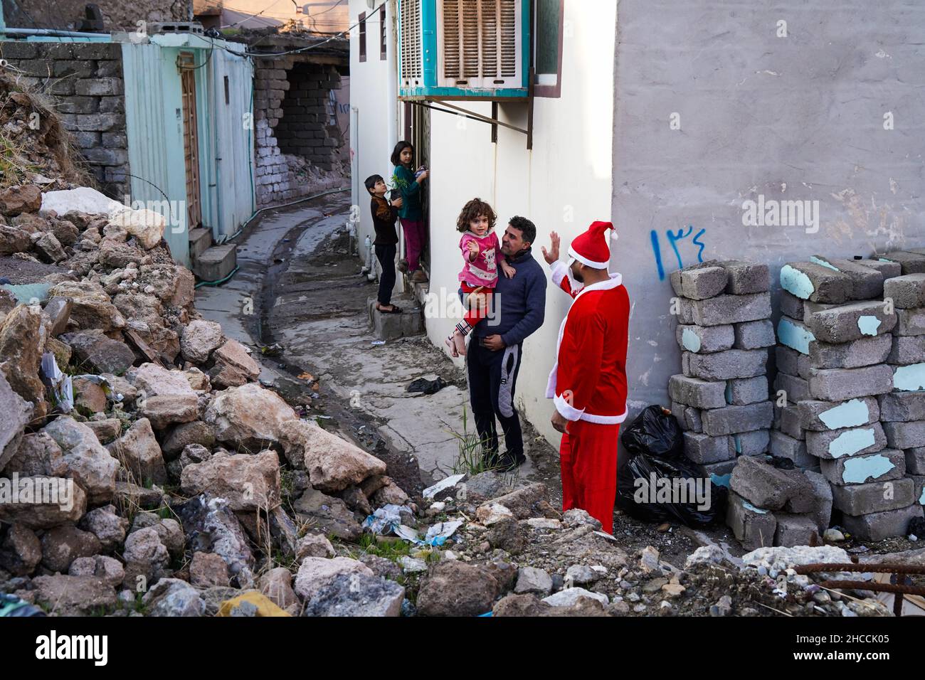 A man dressed as Santa Claus interacts with children after giving them ...