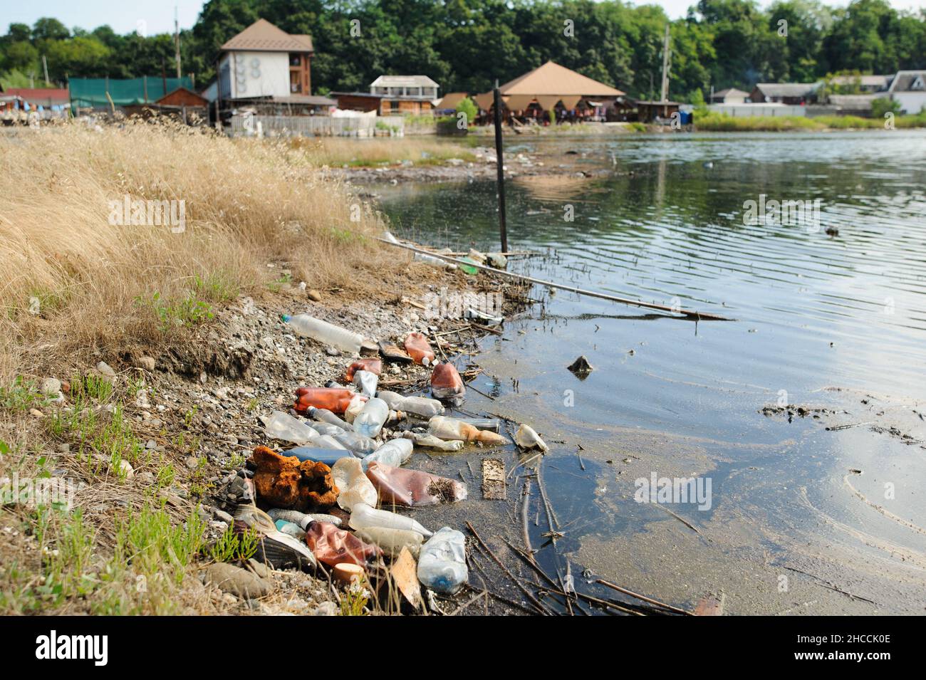 The lake and the shore are littered with the garbage Stock Photo - Alamy