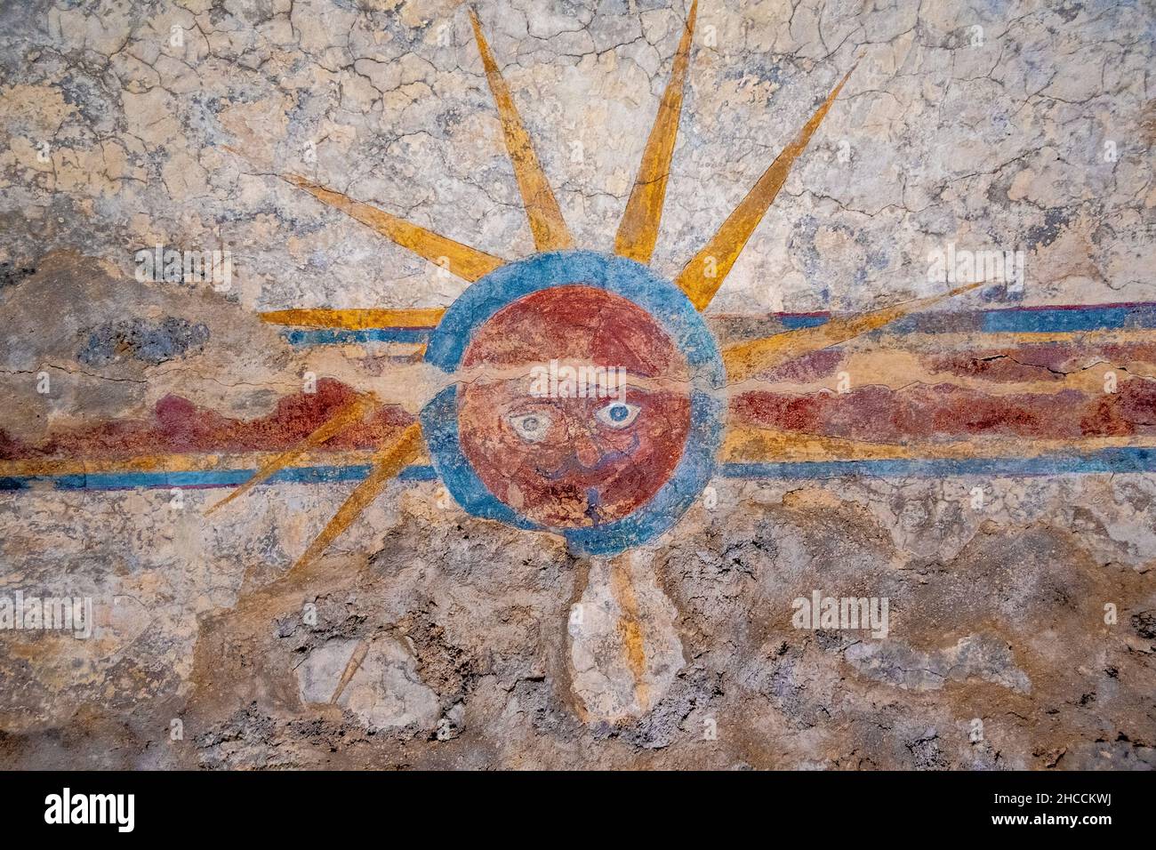 Weathered wall art of a sun with a face Stock Photo - Alamy