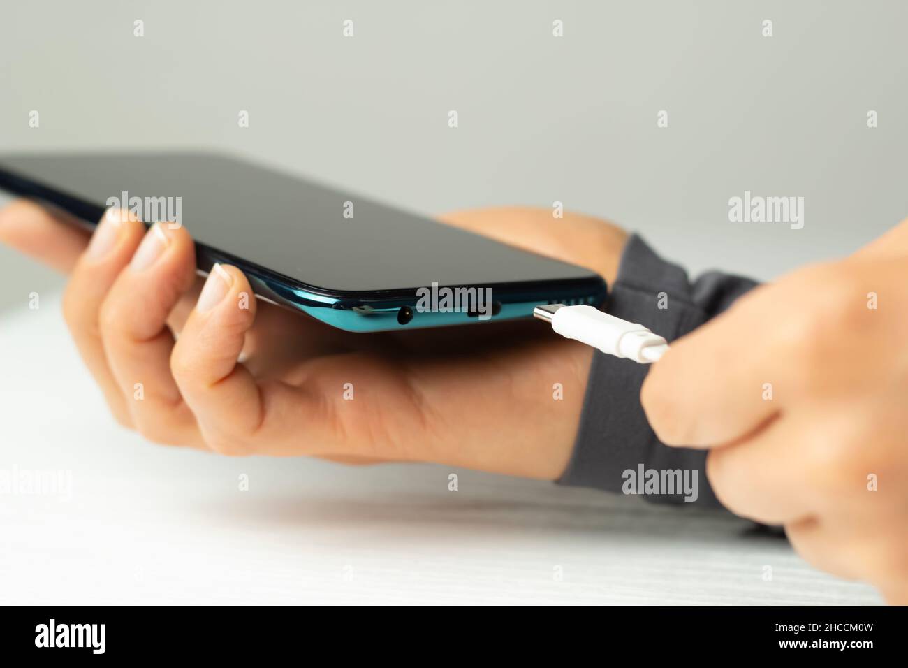 The plug connects to charge the mobile phone battery. Close-up of a ...