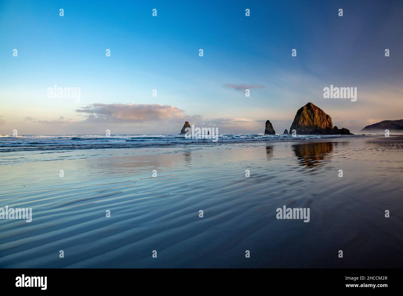 Haystack Rock reflected on water and ripples, Cannon Beach, Oregon USA ...