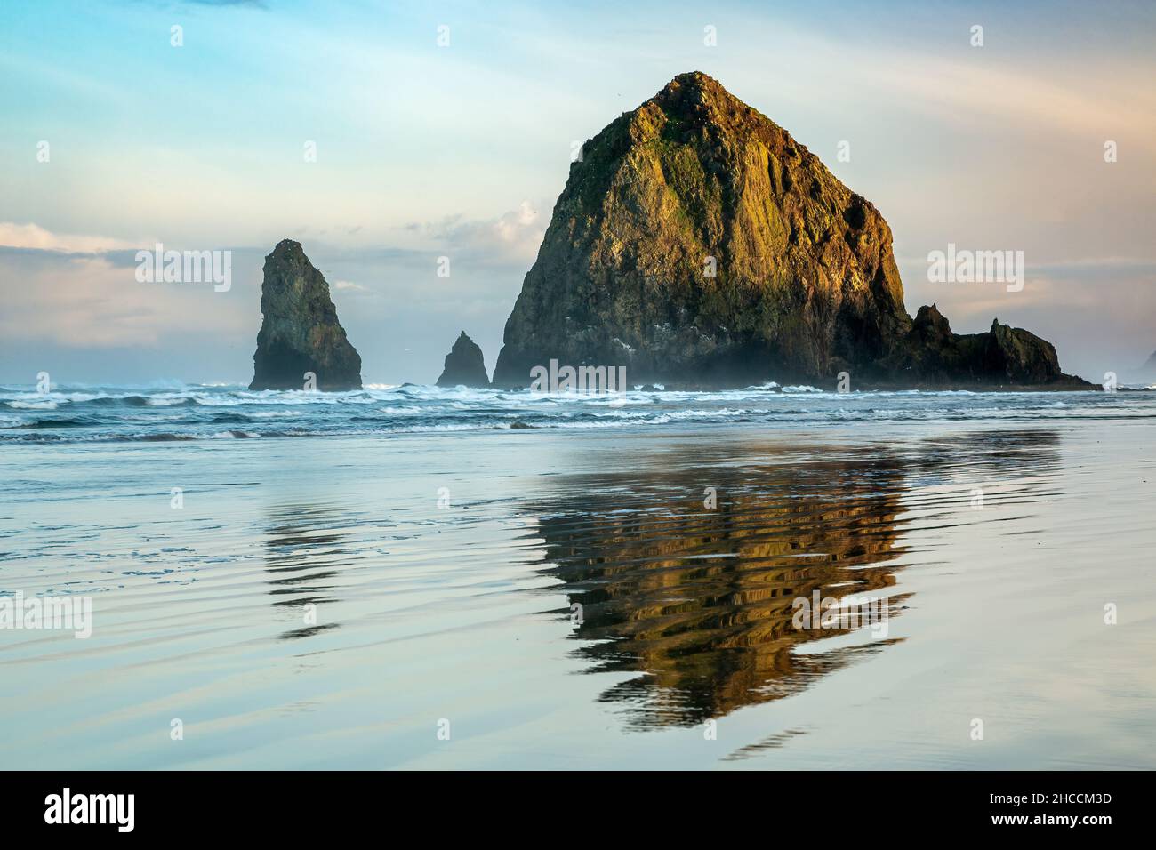 Haystack Rock reflected on water and ripples, Cannon Beach, Oregon USA ...