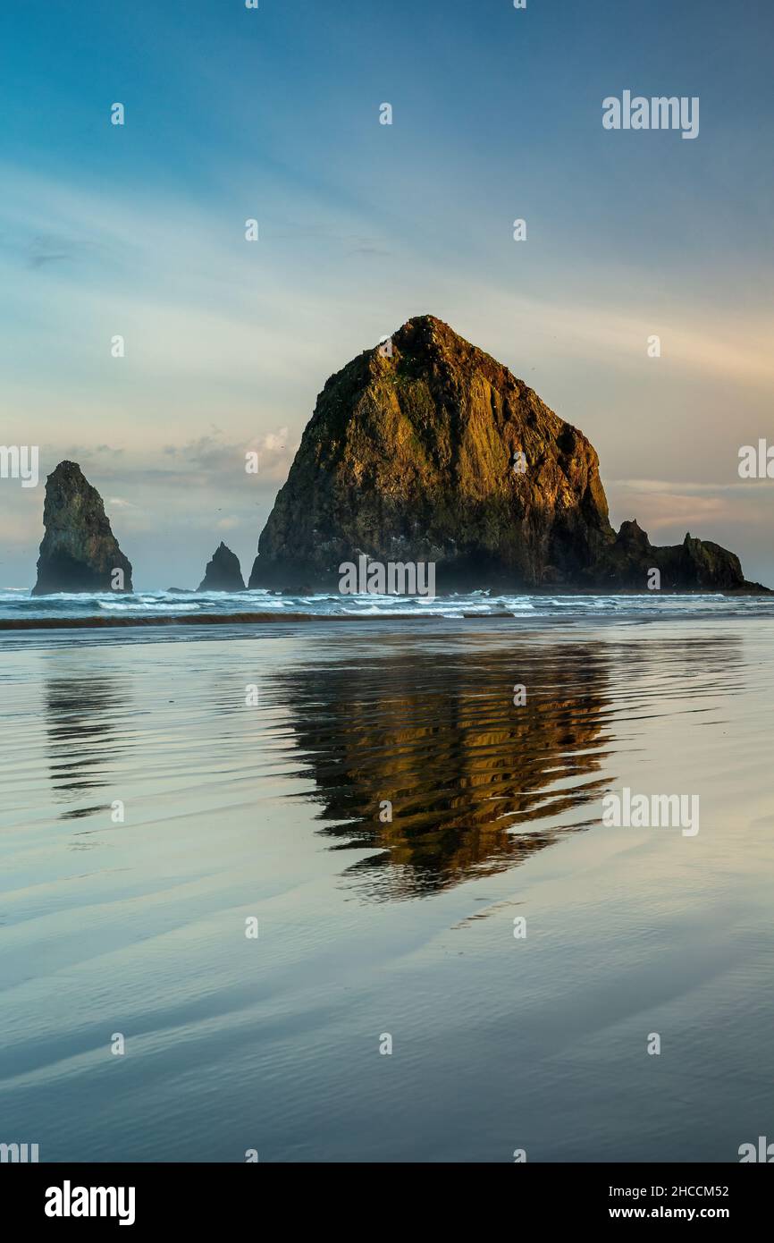 Haystack Rock reflected on water and ripples, Cannon Beach, Oregon USA ...