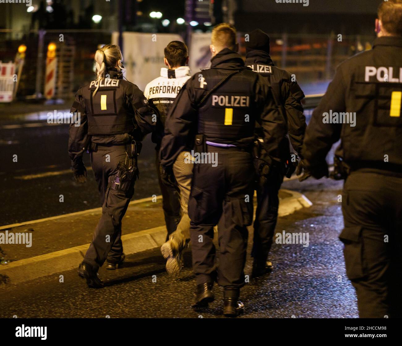 Bad Homburg, Germany. 27th Dec, 2021. Police officers take away a ...
