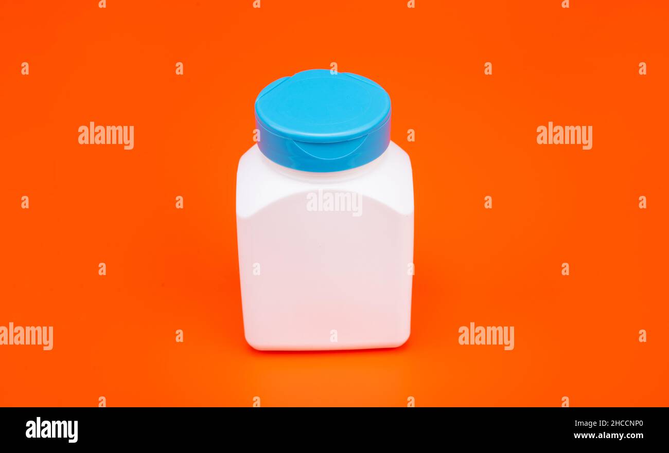 drug jar white color on orange background, vitamin Stock Photo - Alamy