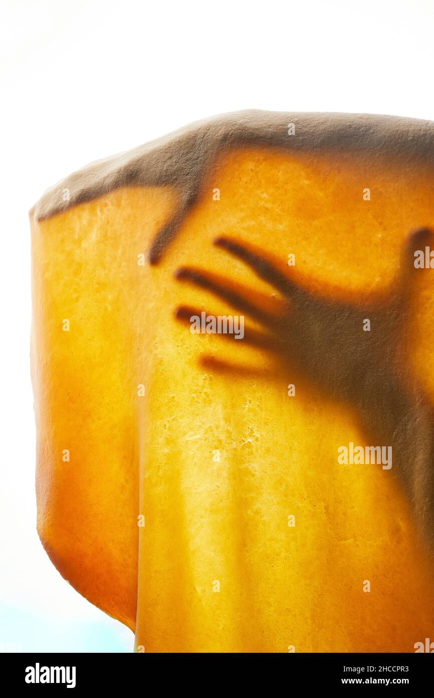 Closeup of hands under the yellow cloth Stock Photo - Alamy