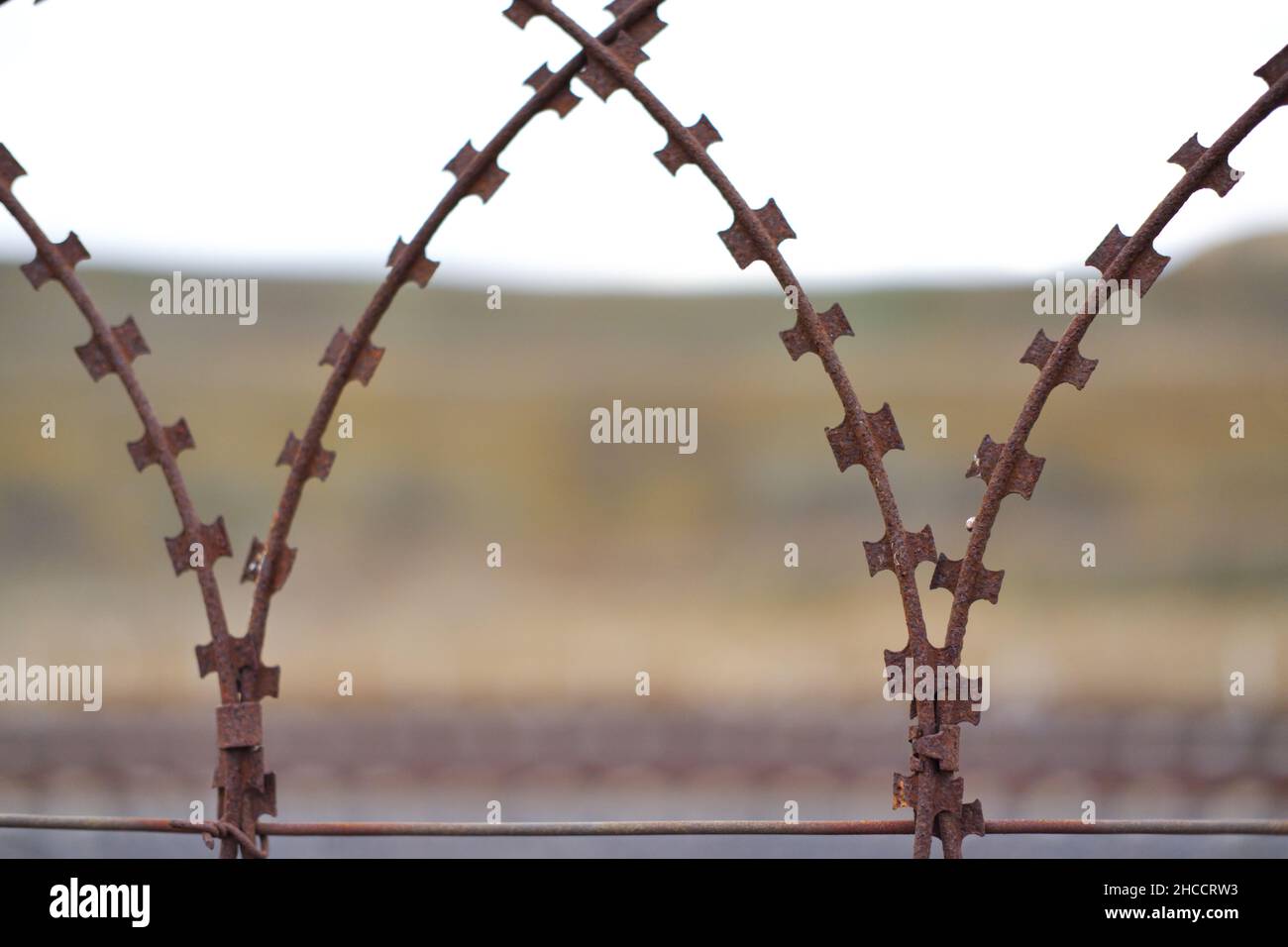 Rusty razor wire barrier outdoor Stock Photo - Alamy
