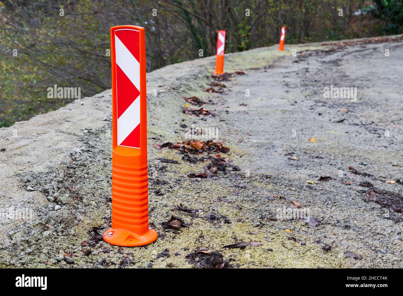 Right turn direction, protective road signs are on a turning mountain ...
