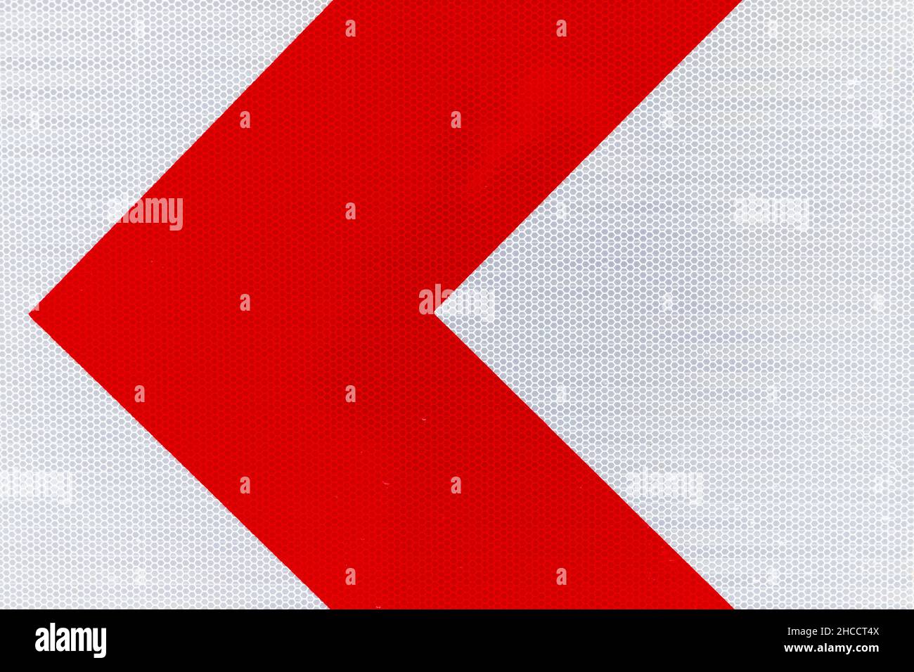 Left turn direction, red and white road sign mounted on roadside, close ...