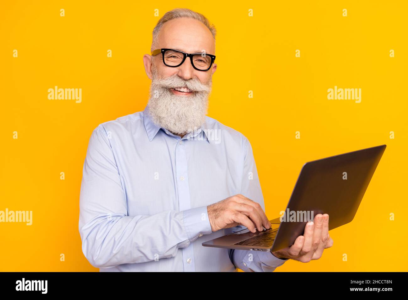Photo of attractive positive old man hold laptop wear glasses ...