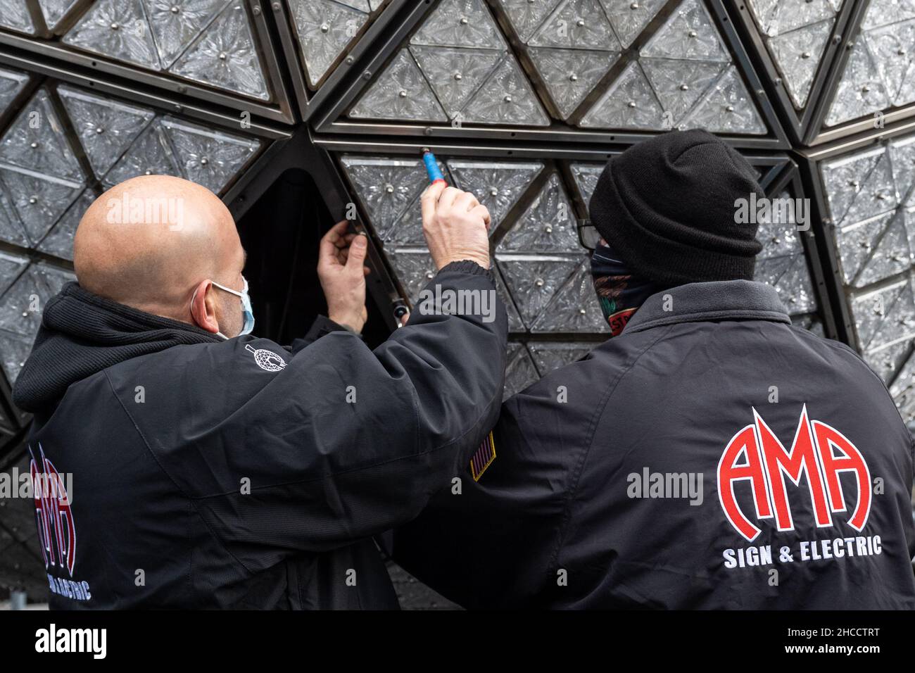 Robert Stults and Nicholas Bonavita of AMA Electric & Signs install the ...