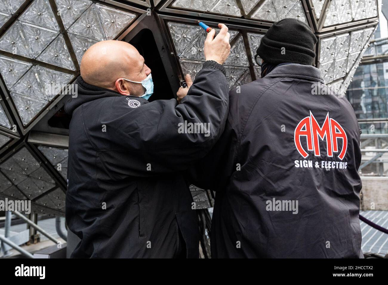 Robert Stults and Nicholas Bonavita of AMA Electric & Signs install the ...