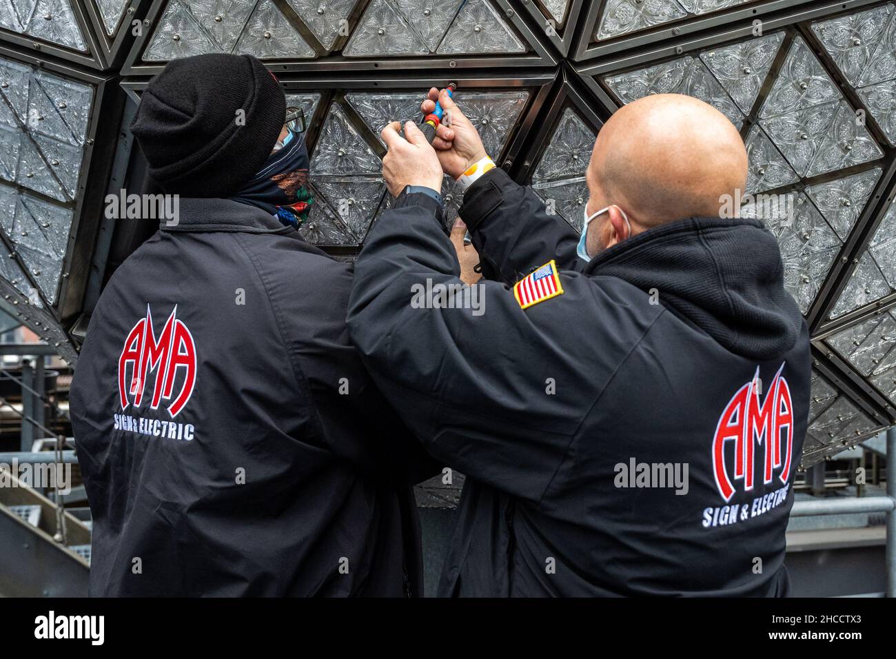Nicholas Bonavita and Robert Stults of AMA Electric & Signs install the ...