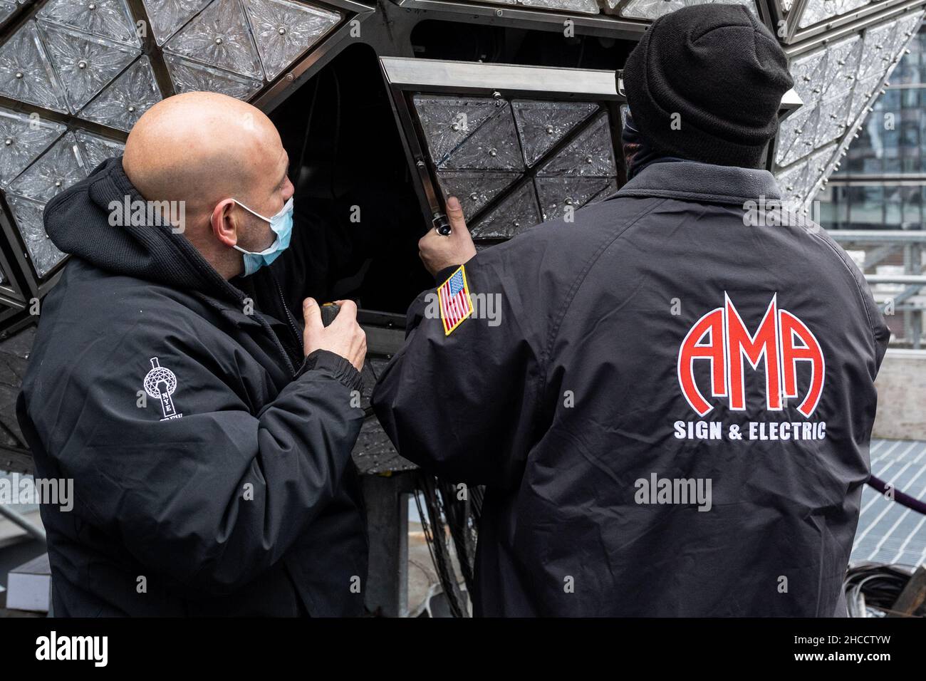 Robert Stults and Nicholas Bonavita of AMA Electric & Signs install the ...