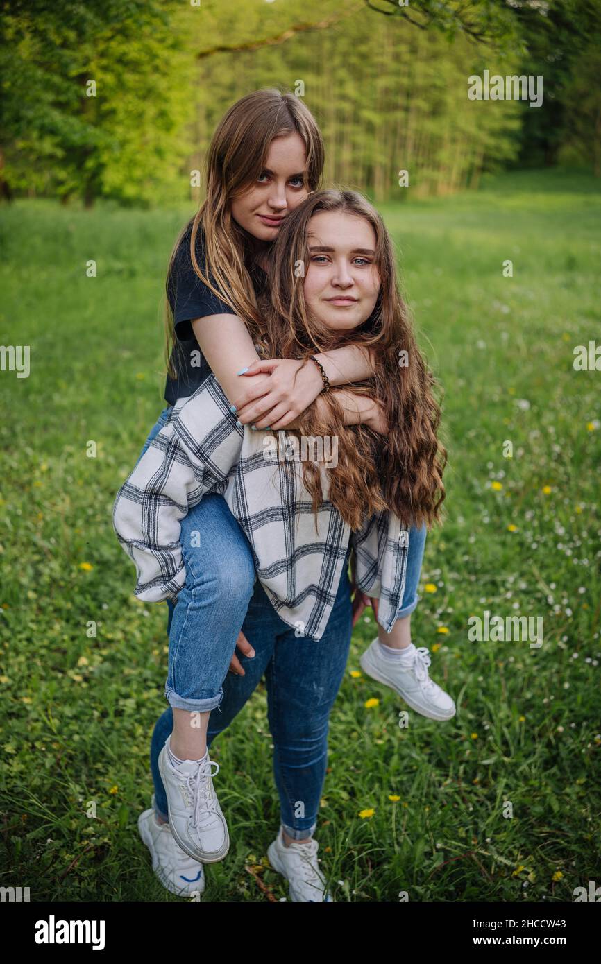 Portrait of two girlfriends, one of whom is on the back Stock Photo - Alamy