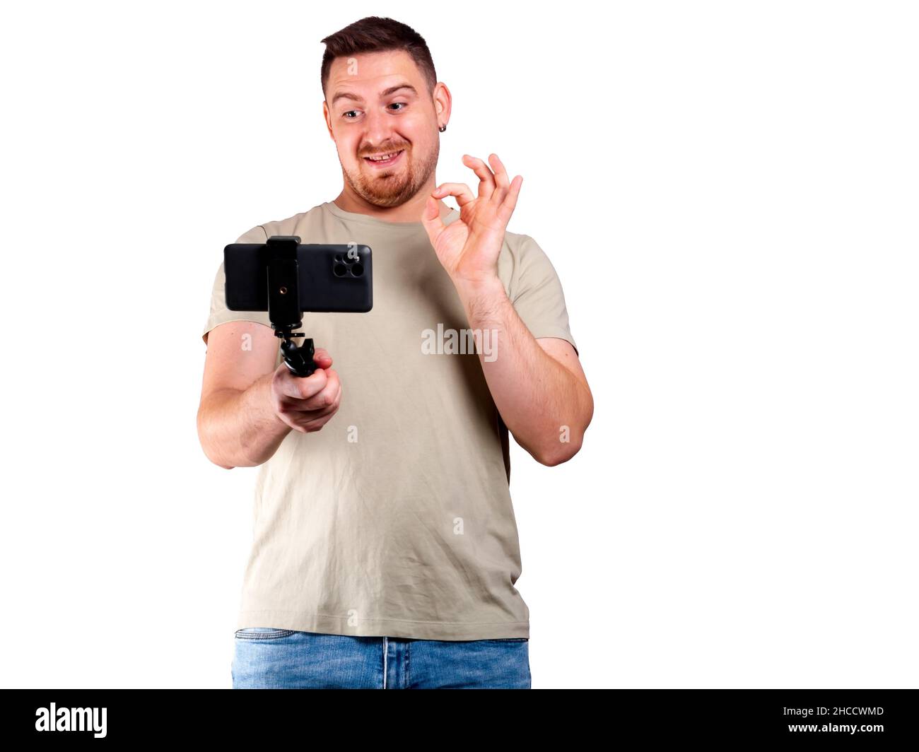 Spanish man doing a selfie with a selfie stick isolated on a white ...