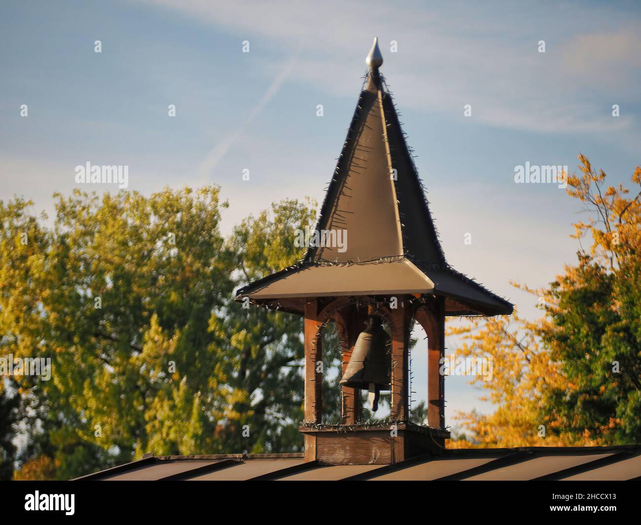 Rooftop of a church with a metal bell Stock Photo - Alamy