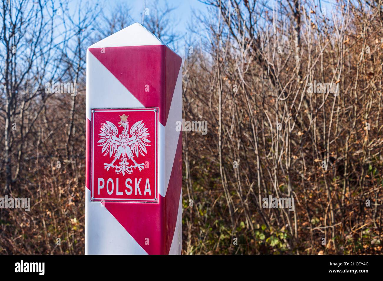 Polish, white and red border post. On the pole, there is a white eagle ...
