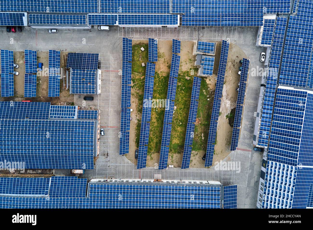 Aerial view of blue photovoltaic solar panels mounted on industrial ...