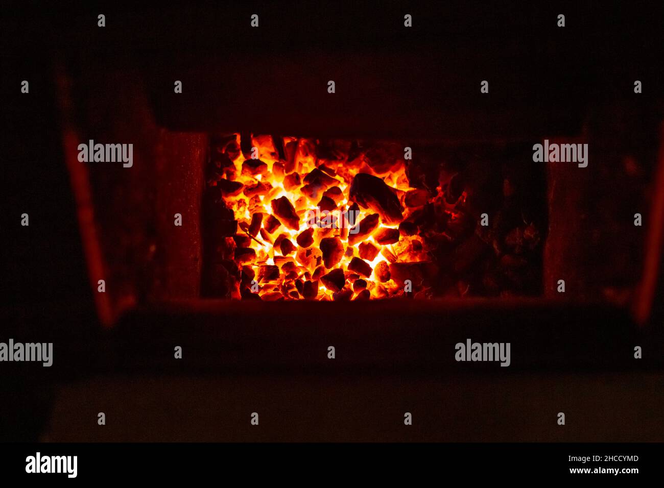 Burning coals in a solid fuel boiler. Heating of a residential building ...