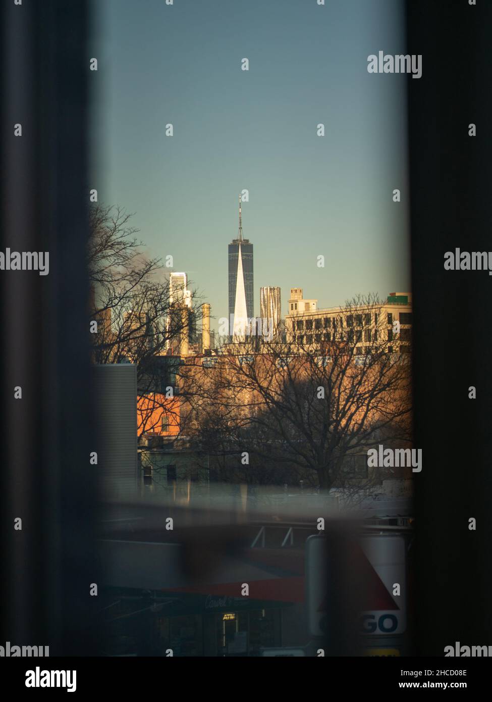 Vertical shot from behind a window of a tower and buildings Stock Photo ...