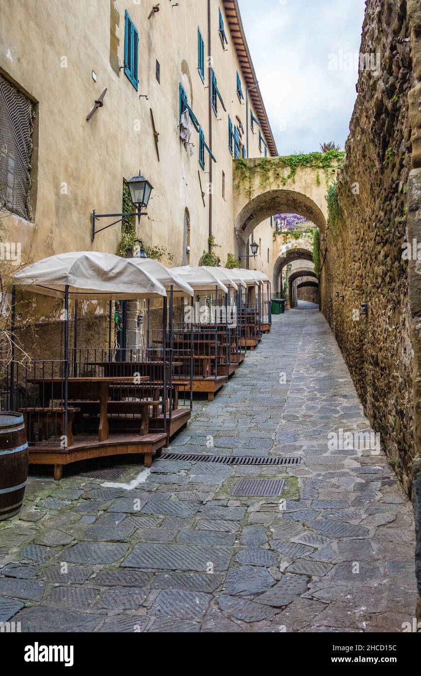 Vertical shot of an alley surrounded by old buildings in Italy Stock ...