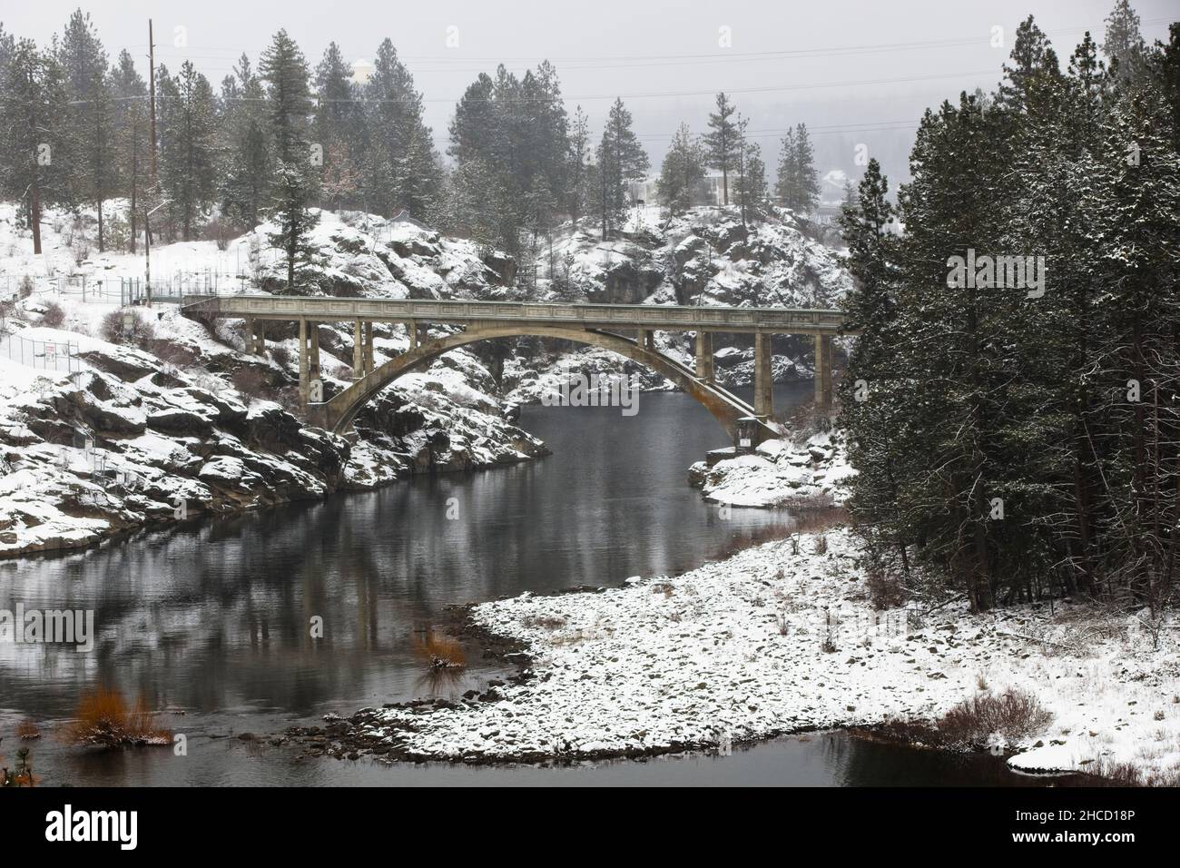 Old bridge spans across the Spokane River during winter in Post Falls ...