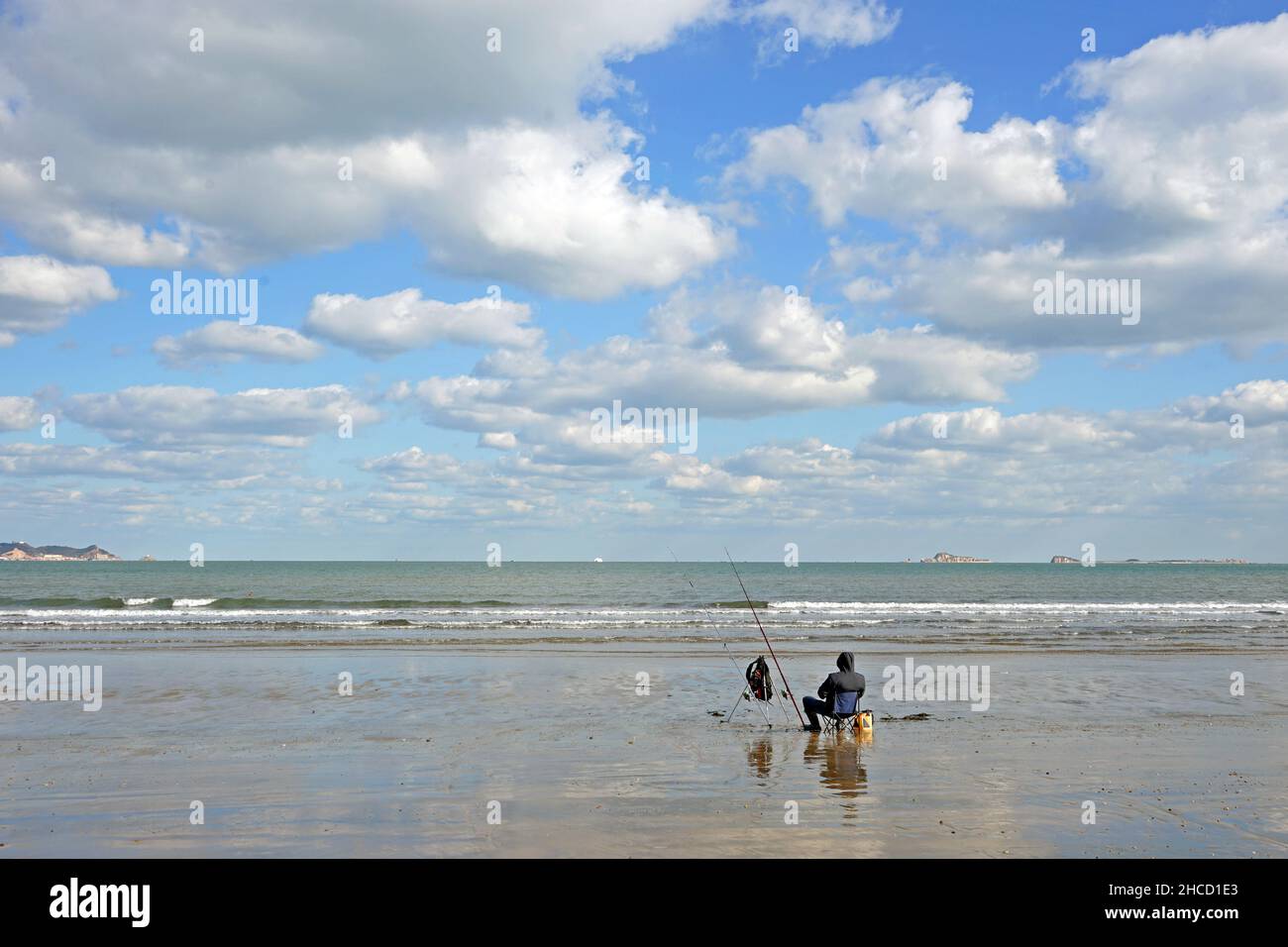 YANTAI, CHINA - NOVEMBER 12, 2021 - A citizen fishes at a beach in ...