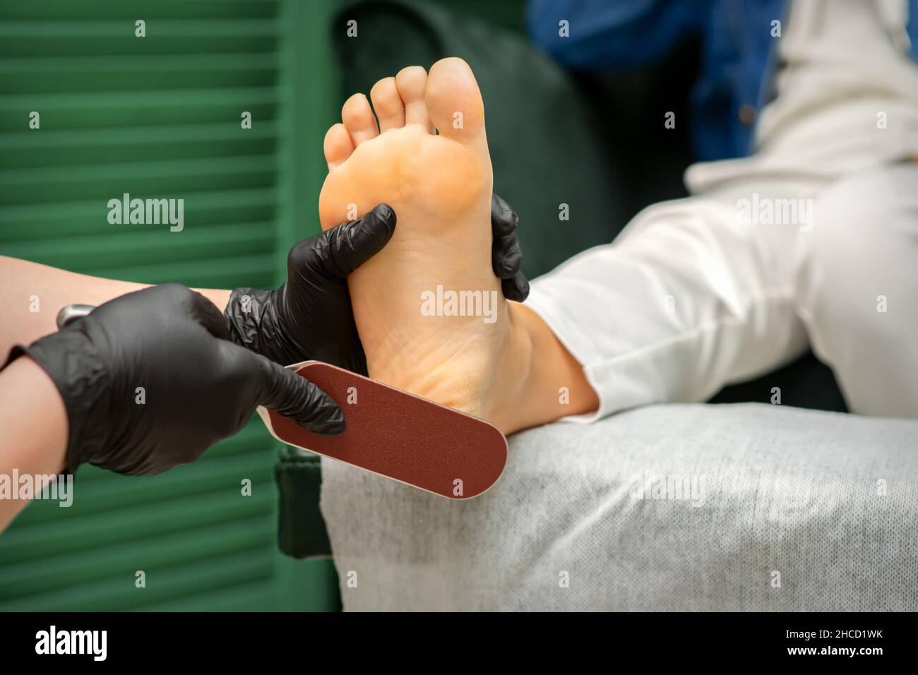 Peeling of Heels. Hands of pedicure master scrape dead from heel skin ...