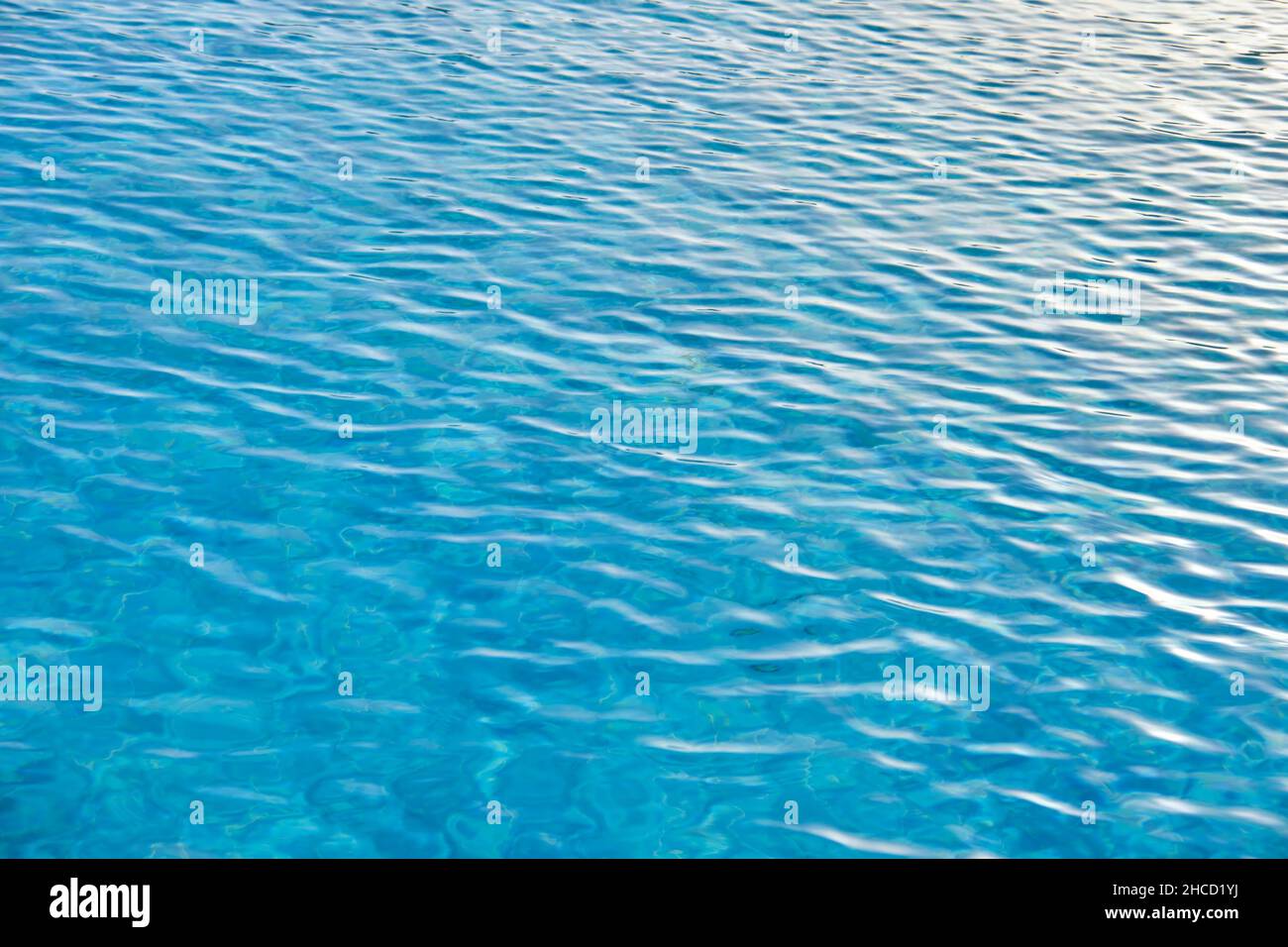 Closeup surface of blue clear water with small ripple waves in swimming ...