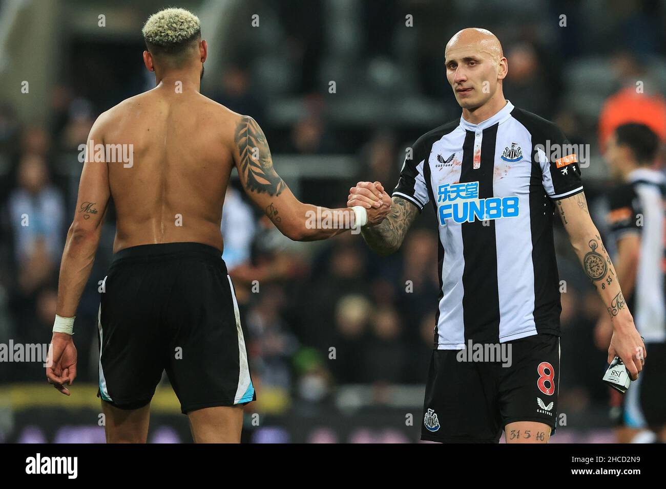 Joe linton #7 of Newcastle United shakes hands with team mate Jonjo ...