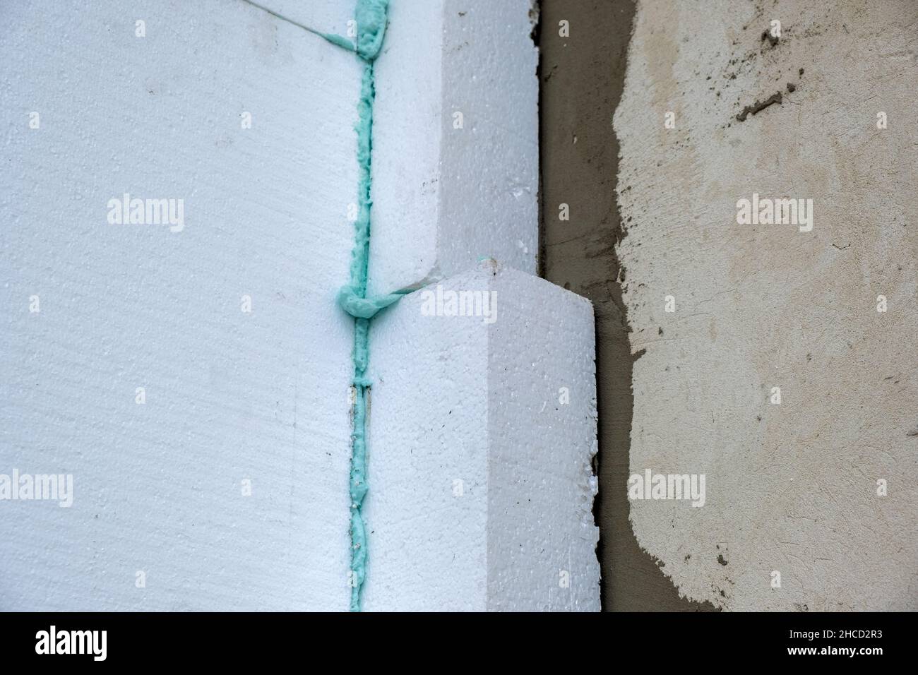 Installation of styrofoam insulation sheets on house facade wall for ...