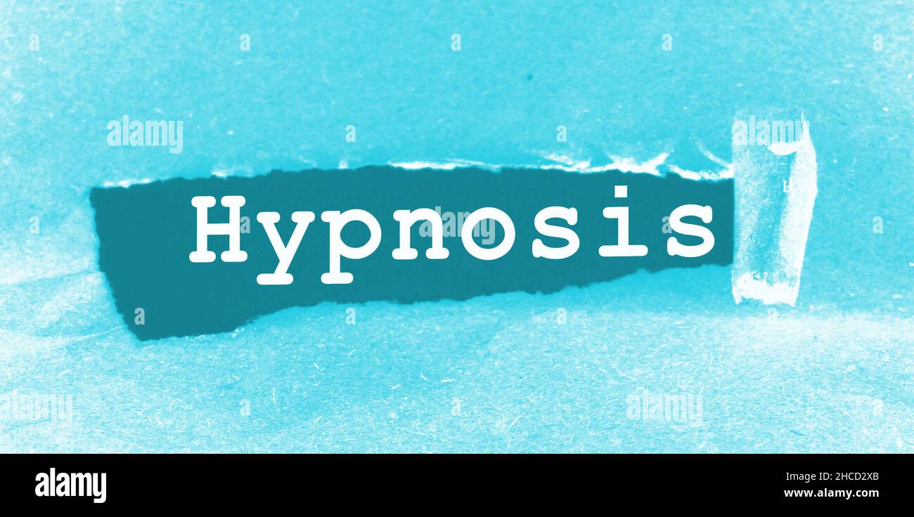 Hypnosis word typed white on black appearing behind torn brown paper ...
