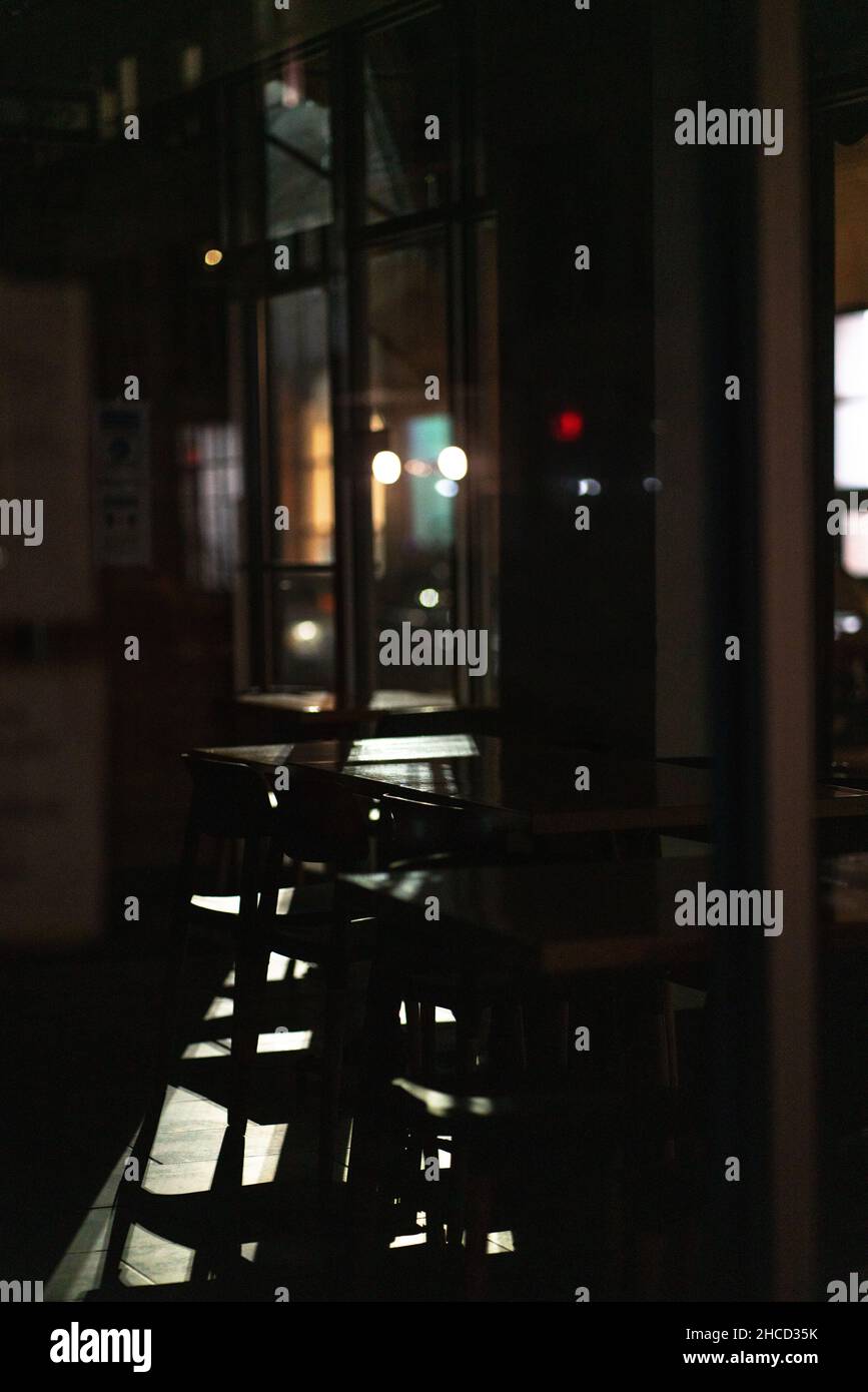 Vertical shot of the street lights coming inside through a glass window ...