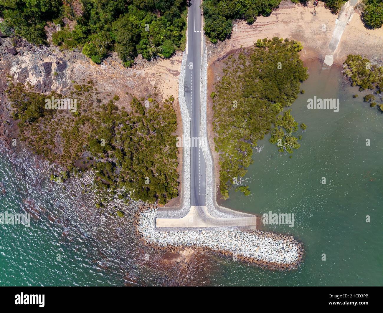 Directly above a boat ramp on the ocean with surrounding vegetation at ...