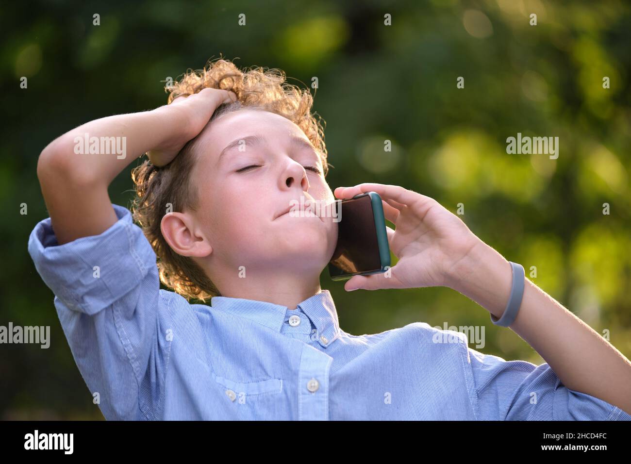 Young boy having an argument while talking on cellphone outdoors in ...
