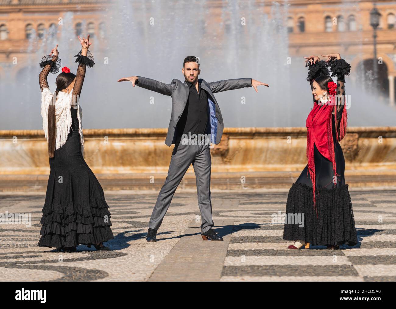 Three caucasian people dancing flamenco in a traditional square Stock ...