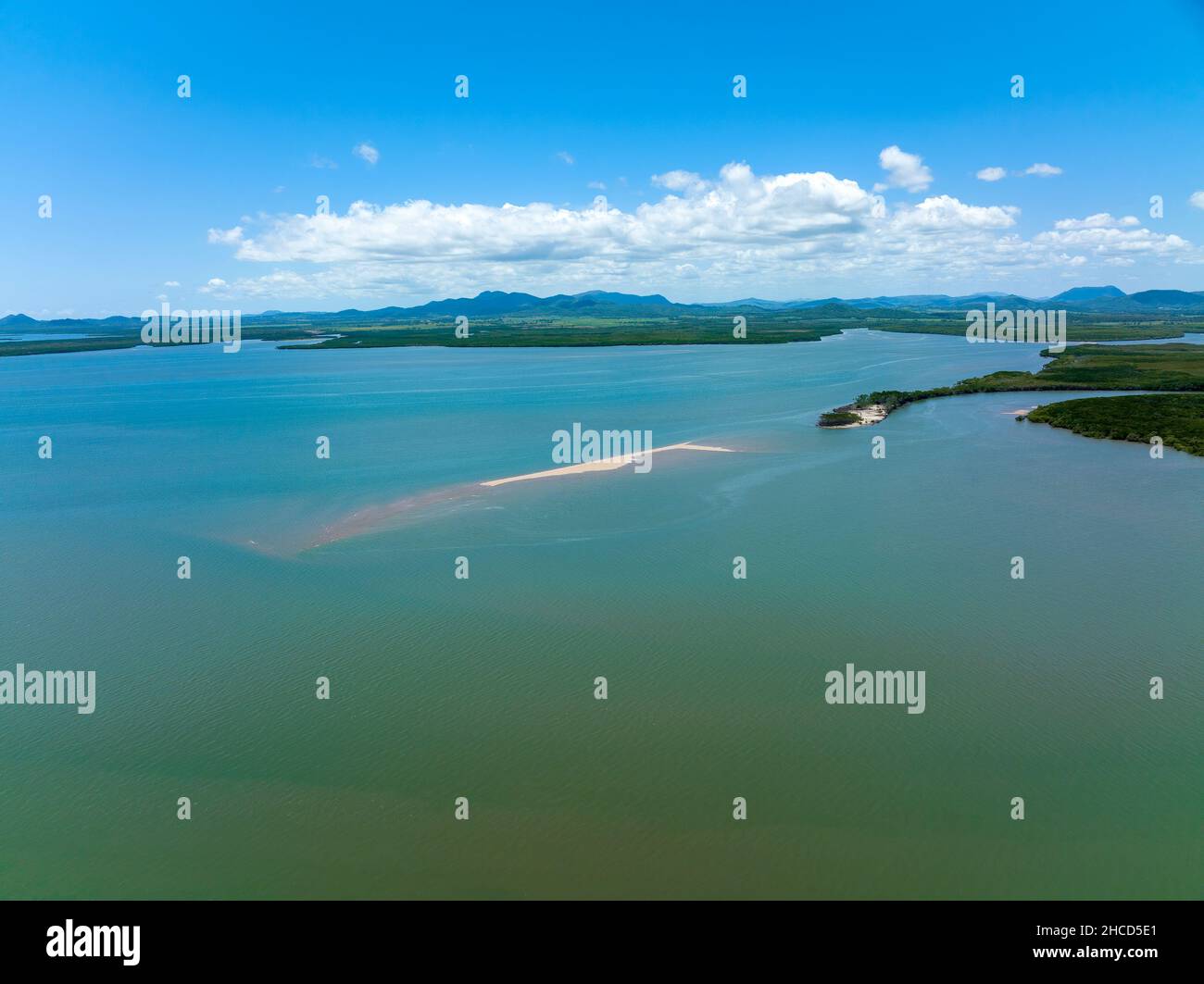 Aerial landscape of seawater flowing into a tidal creek surrounded by ...