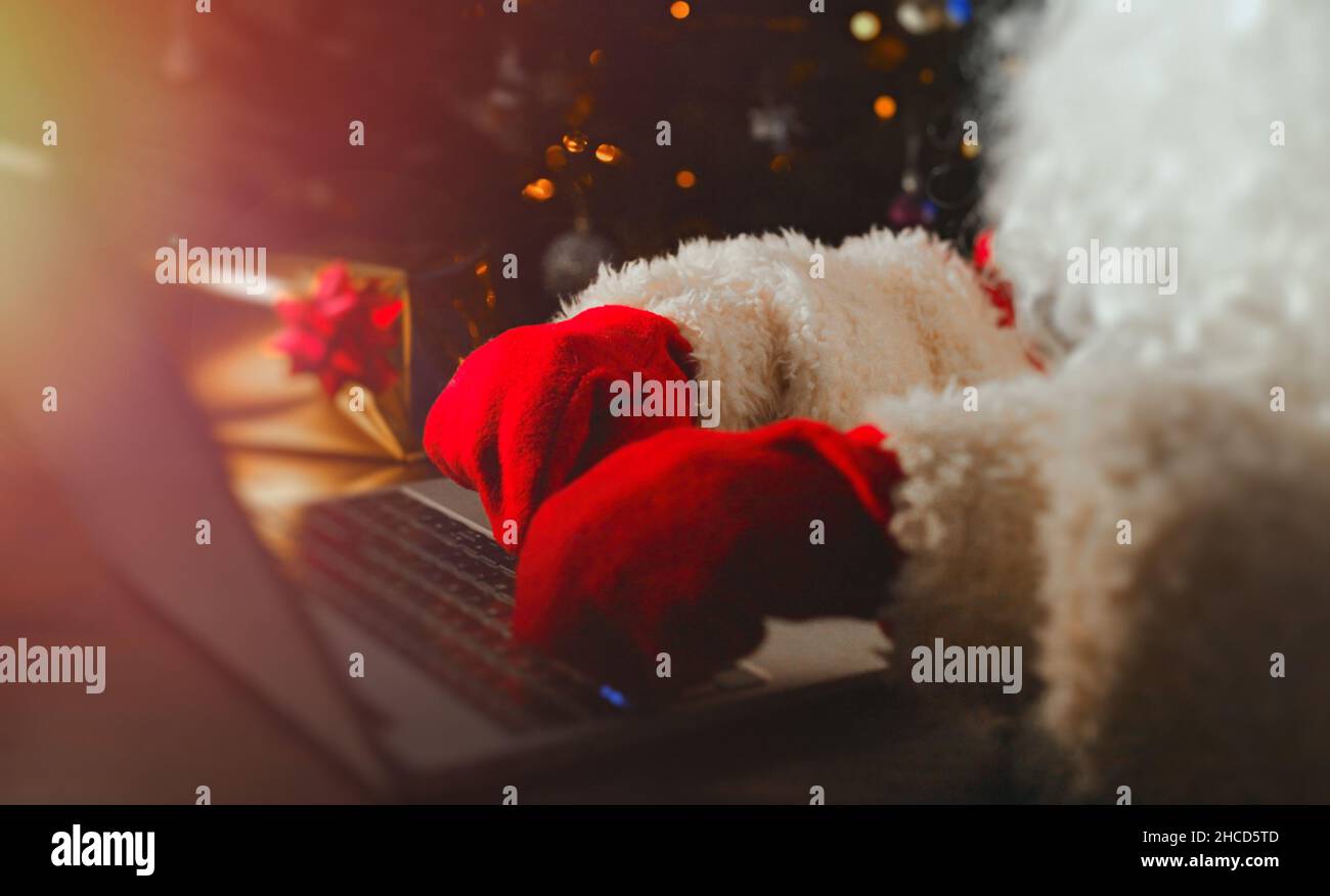 Santa claus is typing a letter on the computer Stock Photo - Alamy
