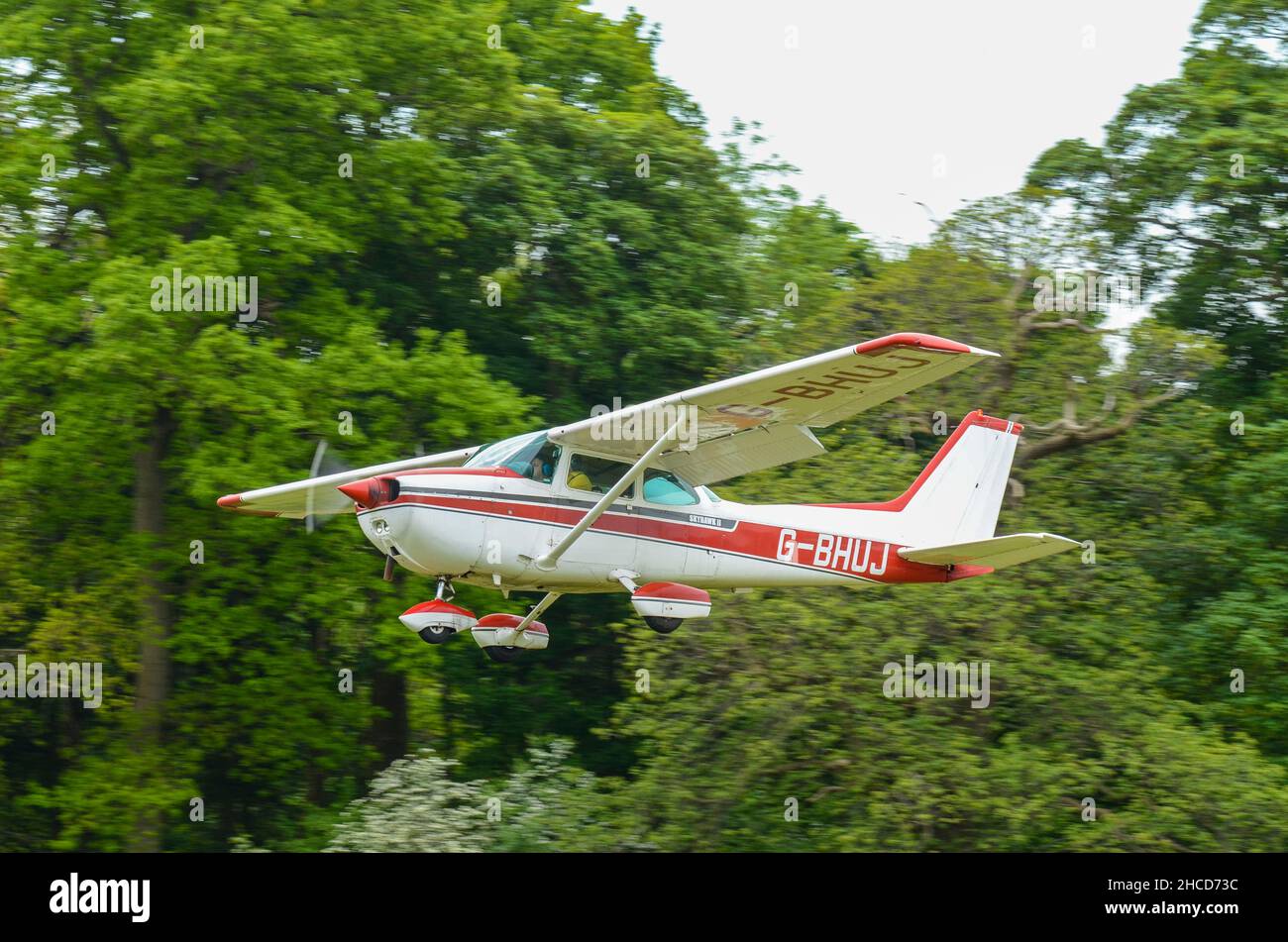 Cessna 172N Skyhawk, Cessna 172 Skyhawk, light aircraft plane G-BHUJ taking off from a grass ...